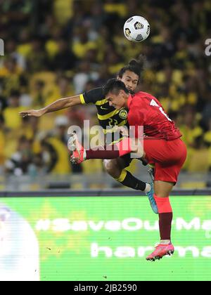Law Tsz-Chun (7) of Hong Kong vies for the ball with Glenn Kweh Jia Jin ...