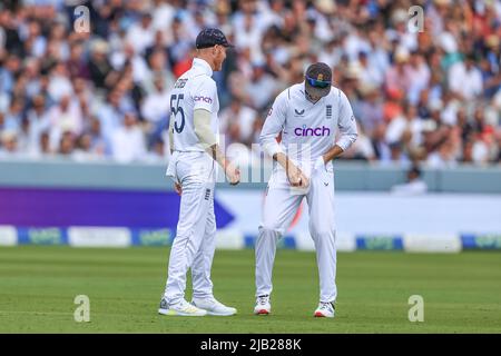 Joe Root of England polishes the ball for Ben Stokes of England Stock ...