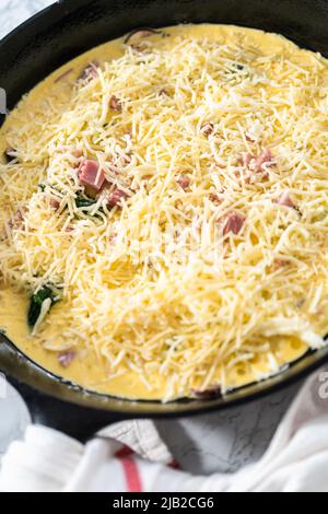 Preparing spinach and ham frittata in cast iron skillet Stock Photo - Alamy
