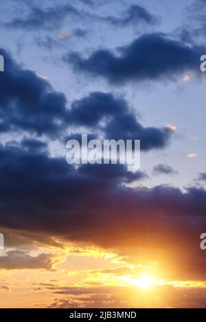 Thunderclouds with breaking rays sun at sunset Stock Photo - Alamy