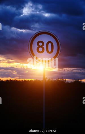 Speed limit sign of 80 km h background bright sunset and clouds Stock ...