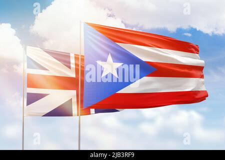 flags of great Britain and Puerto Rico waving in the wind on flagpoles ...