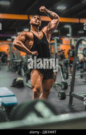 tall male bodybuilder flexing muscles for fitness Stock Photo - Alamy