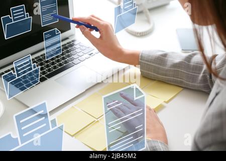 Young businesswoman with sticky note papers on clipboard against blue ...