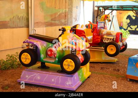 Coin operated amusement kiddie rides Stock Photo - Alamy