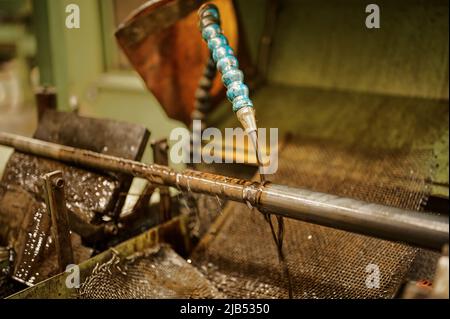 Liquid honing of drill rod with lubricant in workshop Stock Photo - Alamy