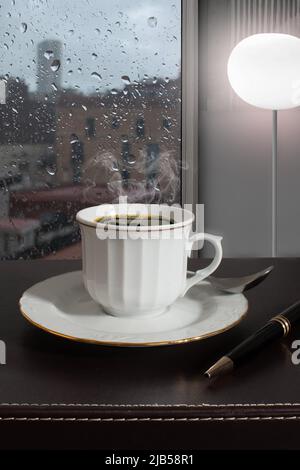 A cup of cold coffee in rainy day Stock Photo - Alamy