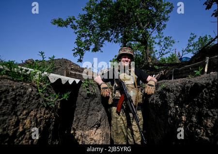 A Ukrainian Territorial Defence Forces serviceman points a rifle from a ...