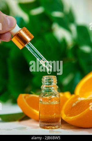 lemon essential oil in a medical bottle with a dropper on a white ...