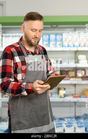 Serious online store employee working in office Stock Photo - Alamy