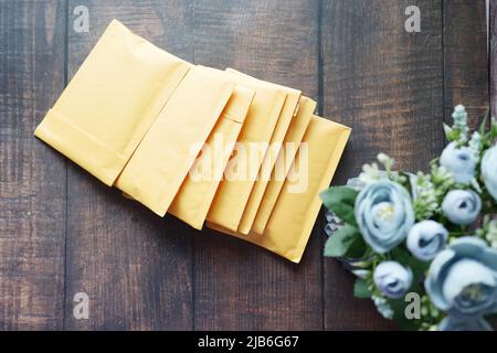 yellow paper bubble envelope on table Stock Photo - Alamy