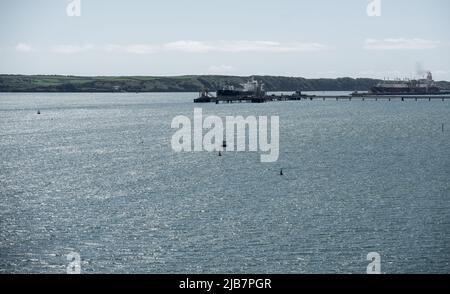 huge oil container ship berthed and unloading to a nearby power station ...