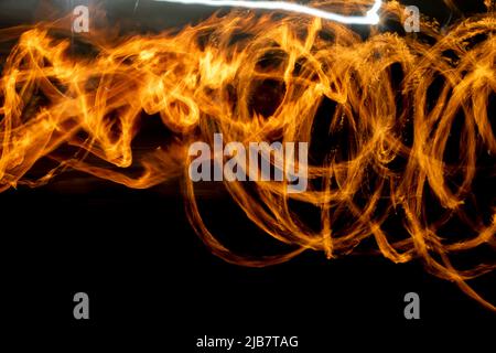 Circles of fire. Lines of flame. Shooting fire show on long shutter ...