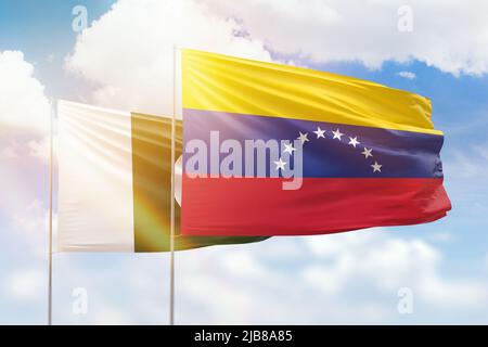 Pakistan and Venezuela flags waving together on blue cloudy sky, two ...