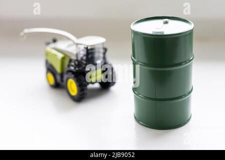 small toy combine with toy oil barrel Stock Photo - Alamy