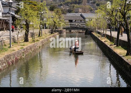 Tourists on a boat ride on the Kurashiki River, Kurashiki Bikan ...
