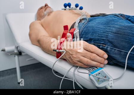 ECG procedure for male patient with electrodes for heart health exam in ...