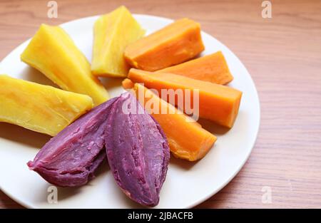 Plate of three different color steamed sweet potatoes, a good source of ...