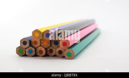 Stack of colorful pencils tips on dark table, art background. Set for ...
