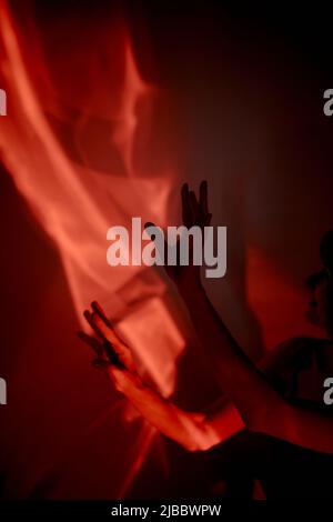 Hands in red light. Abstraction. Shadow theatre, hallucinations Stock ...