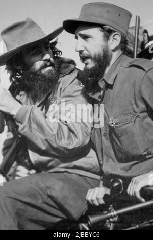 Cuban guerrilla leader Fidel Castro does some reading while at his ...