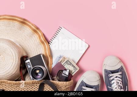 Knitted bag with beach accessories on yellow background Stock Photo - Alamy