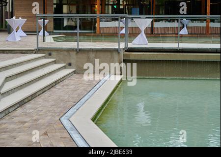 swimming pool drainage system grating covered with round white river ...
