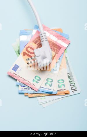 An Electric plug on the on Euro banknote money, electricity prices ...