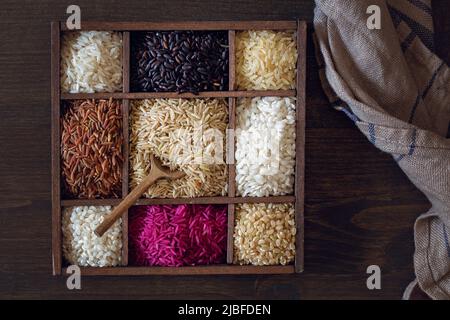 Different types of rice in box on wooden background Stock Photo - Alamy