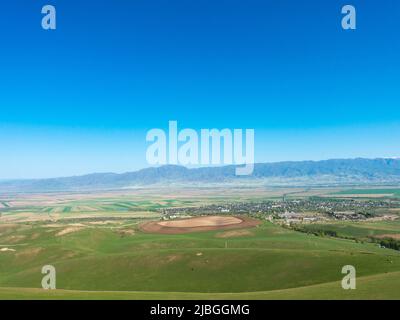 Green slopes and blue skies. Kyrgyzstan Stock Photo - Alamy