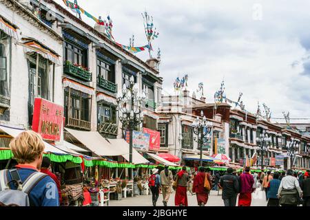 Tibetans and tourists walking through the famous Barkhor Street in ...