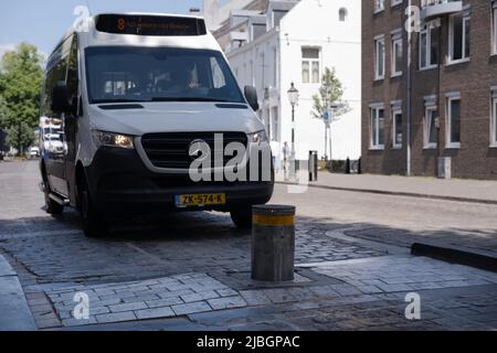 Bus waits for the modern hydraulic bollard to sink into the ground. It ...