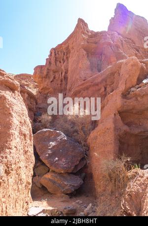 Red rocks and a passage between rocks. Clay canyons. Issyk-Kul region ...