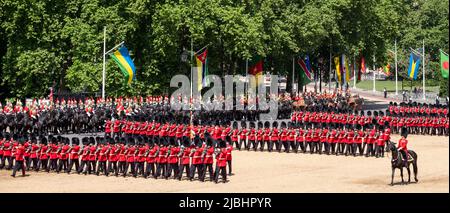 Uniformed guardsmen and women in black and red marching at Horseguards ...