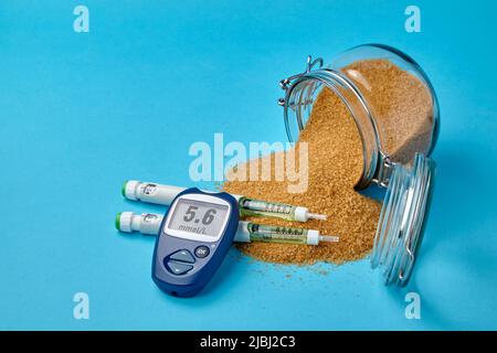 Glucometer with syringes, insulin and sugar on lilac background ...