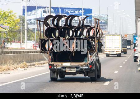 A fully loaded pickup truck carries steel pipes on the highway Stock ...