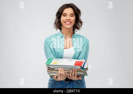 smiling young woman sorting paper waste Stock Photo - Alamy