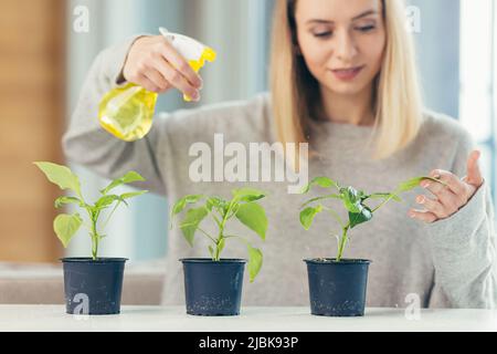 A young woman looks at the camera and takes out a plate from the ...