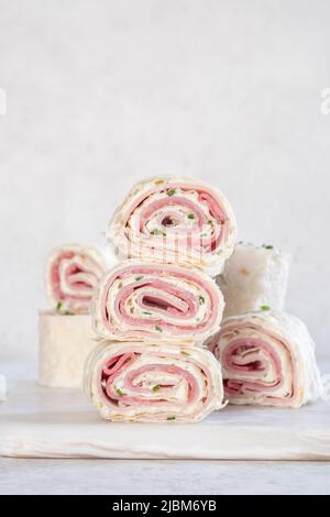 Ham and cream cheese rolled up in a tortilla Stock Photo - Alamy