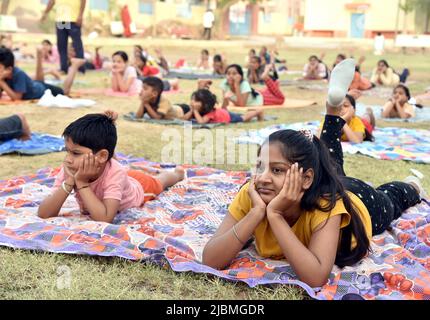 People perform yoga during an event to mark International Yoga Day in ...