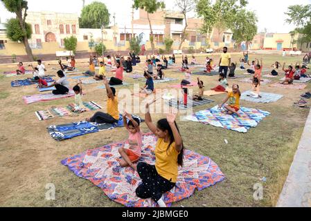 People perform yoga during an event to mark International Yoga Day in ...