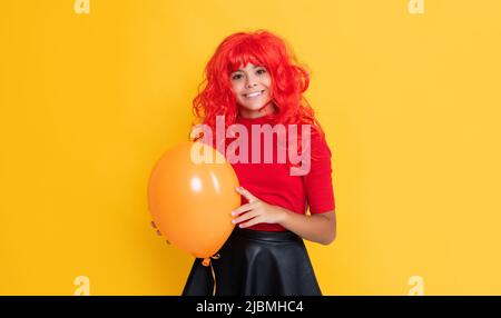 glad redhead girl with curly hair on blue background Stock Photo - Alamy