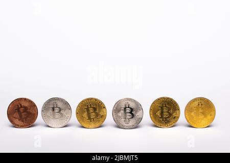 KYIV, UKRAINE - APRIL 26, 2022: Golden bitcoin and cellphone with blank ...