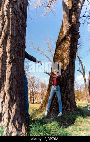 attractive man leaning to forward and holding out his hand to camera ...