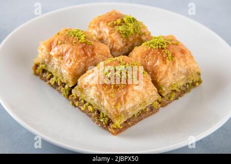 Baklava with pistachio on a white background. Traditional Turkish ...