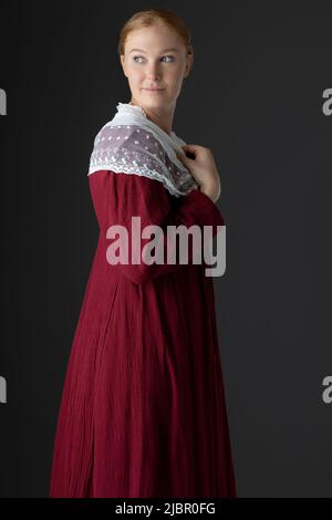 A working class Regency woman wearing a red dress Stock Photo - Alamy