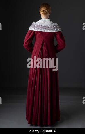 A working class Regency woman wearing a red dress Stock Photo - Alamy