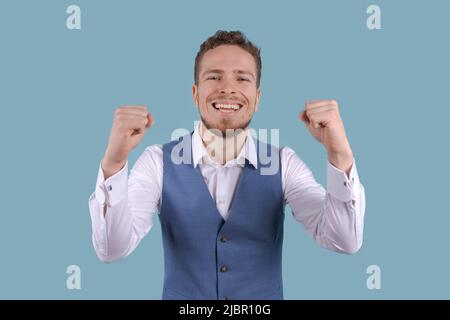 Confident man showing fists against yellow background Stock Photo - Alamy