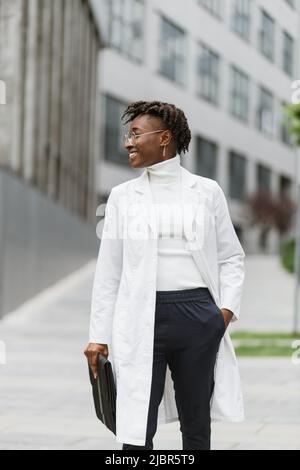 smiling female doctor or scientist with folder Stock Photo - Alamy
