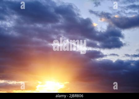 Thunderclouds with breaking rays sun at sunset Stock Photo - Alamy